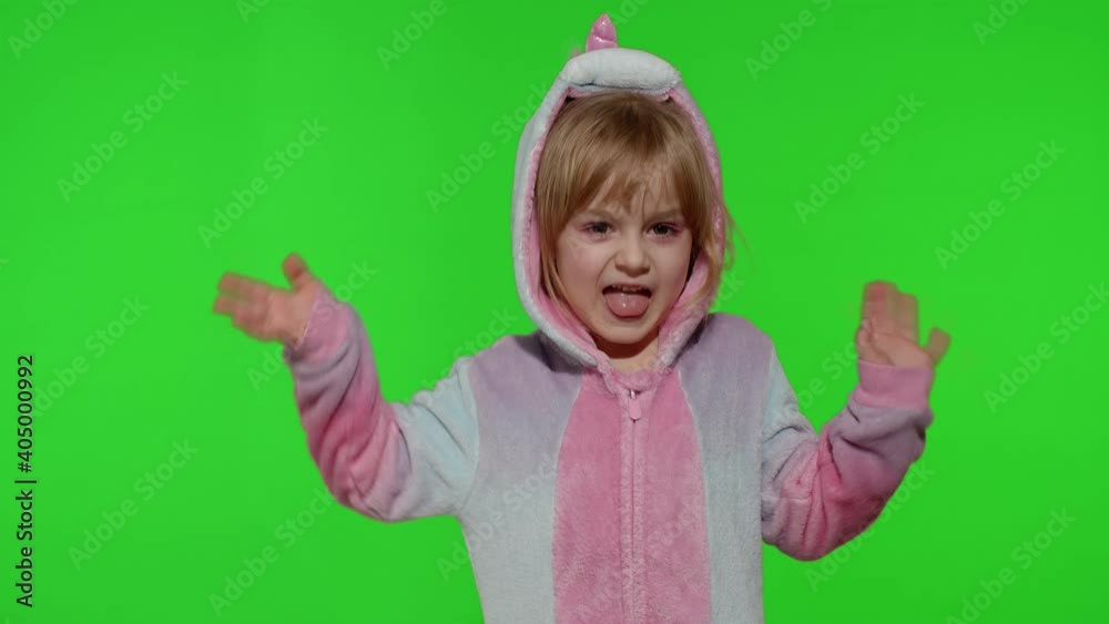 Child making silly funny faces, fooling around, dancing, jumping ...