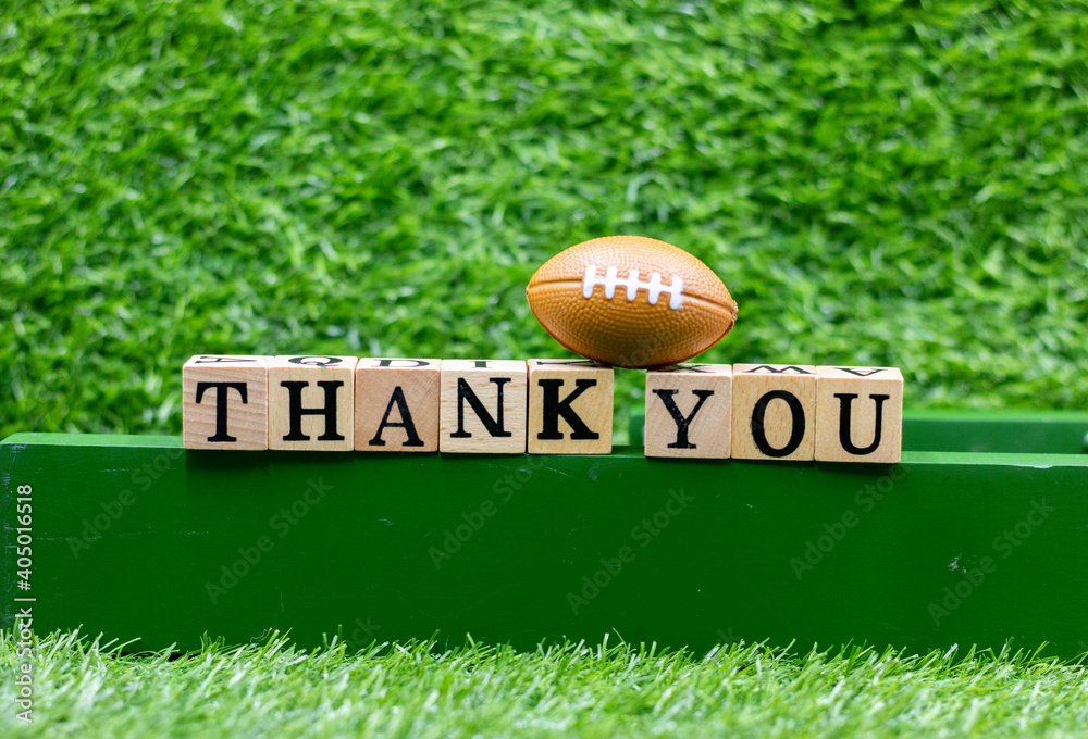 American football with thank you word on green grass Stock Photo ...