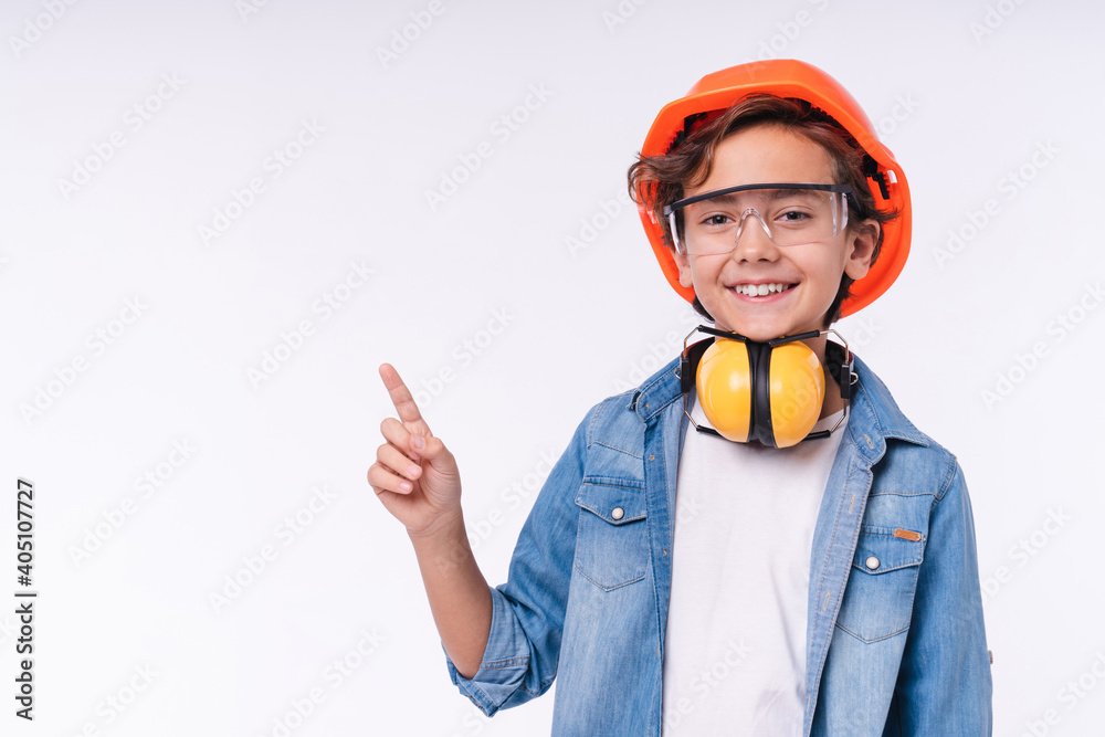 Little funny caucasian boy construction worker in uniform pointing at ...