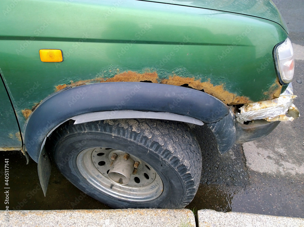 Sheet metal corrosion over wheel of old white car. Rusty messy surface ...