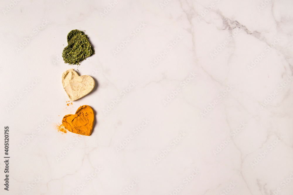 Top view of Three heart shapes of spices on Light Marble background ...
