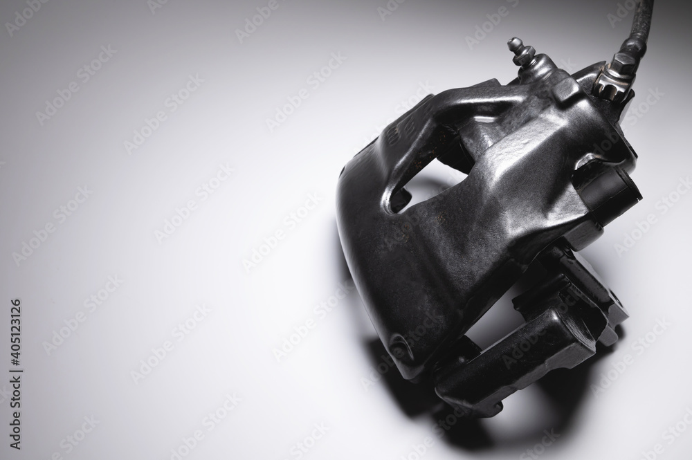 New Brake caliper in black. A spare part for a car brake system on a ...
