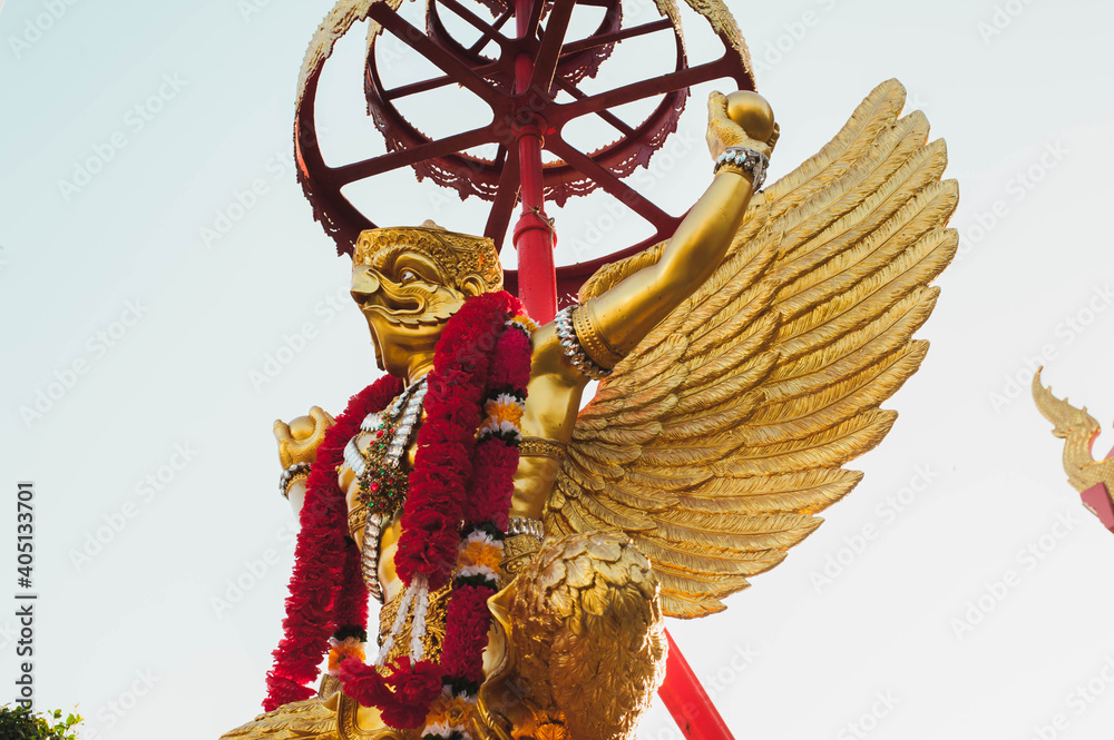 The golden Garuda statue with red garland at Wat Pho thong temple in ...