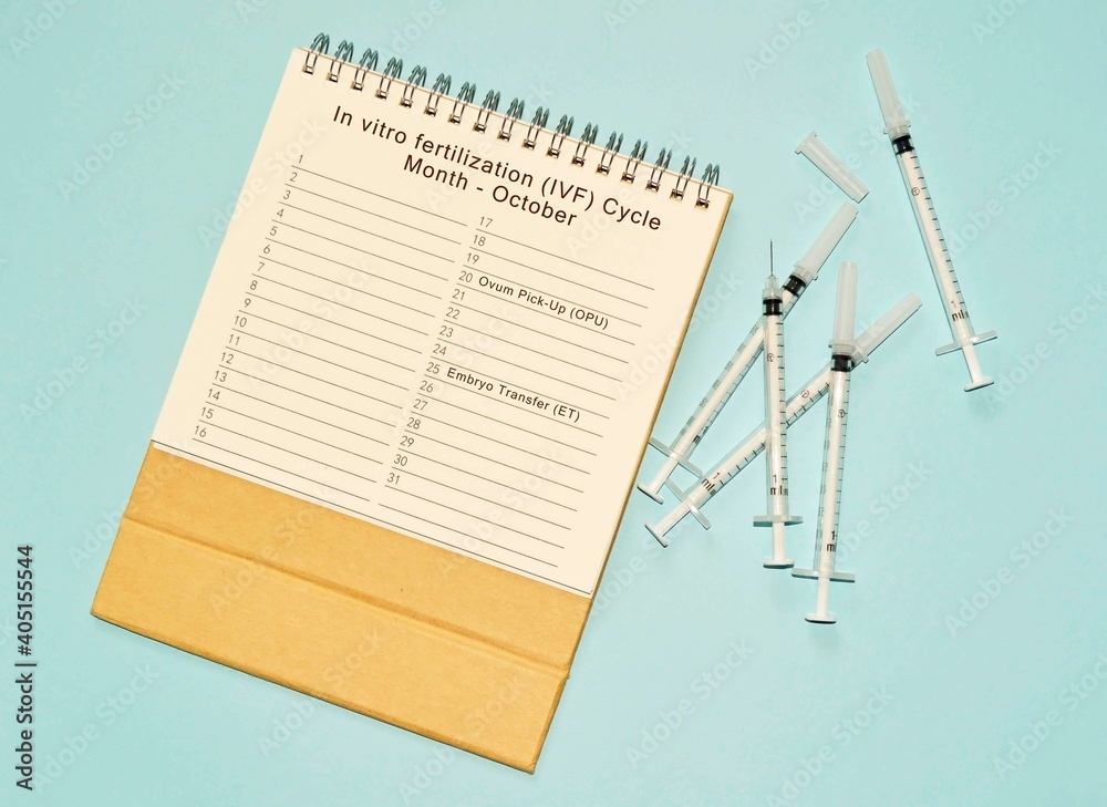 October IVF cycle calendar and disposable injection syringe Stock Photo ...