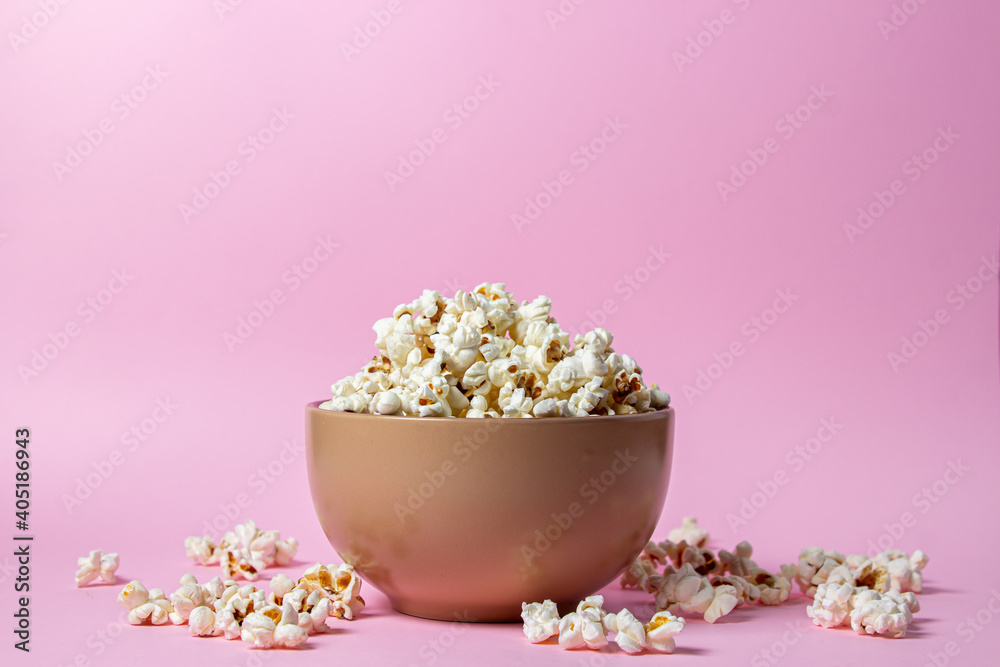 Popcorn on a pink background. A full plate of popcorn. Popcorn is ...