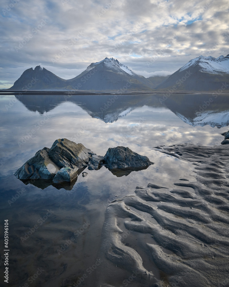 Rocks at shoreline at Papafjörður and Papaós. Mountains Brunnhorn ...