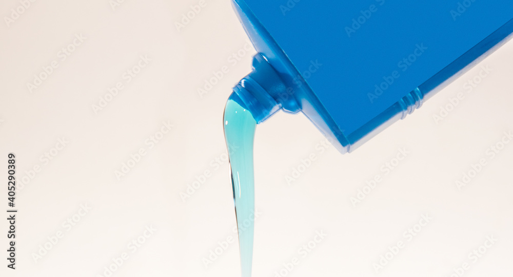 Pouring blue oil conditioner from plastic container Stock Photo | Adobe ...