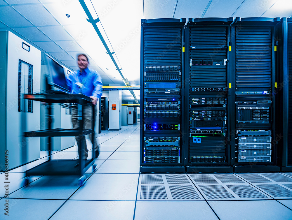 Employee pushing equipment cart in data center Stock Photo | Adobe Stock