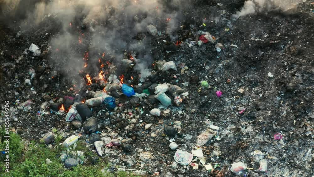 Garbage and fire burn in landfill. Also call trash, waste, rubbish ...