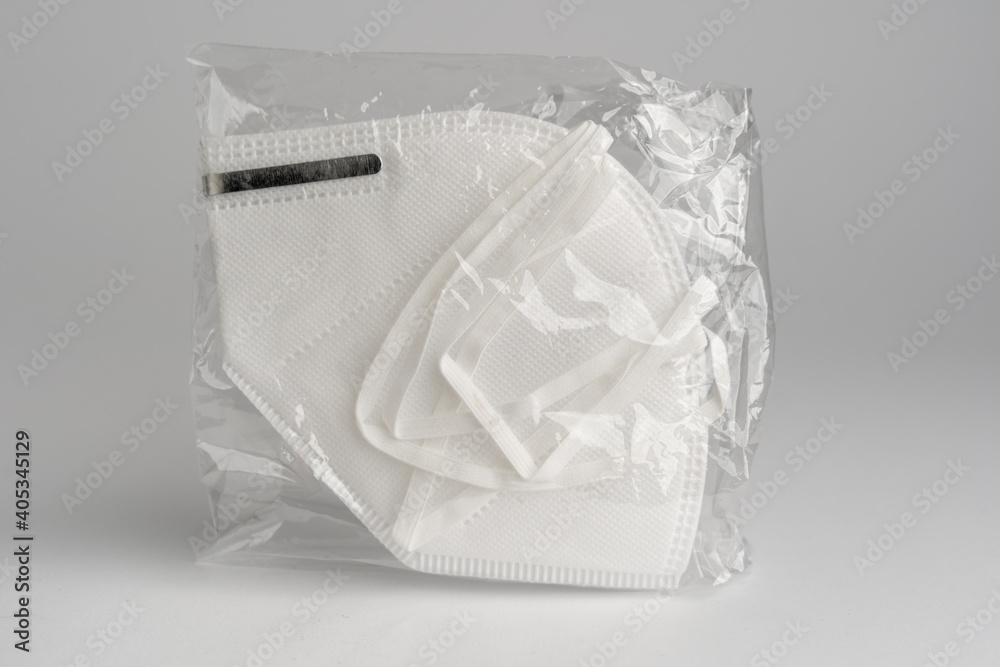 Wrapped FFP2 face mask in white in front of clean background. Certified ...