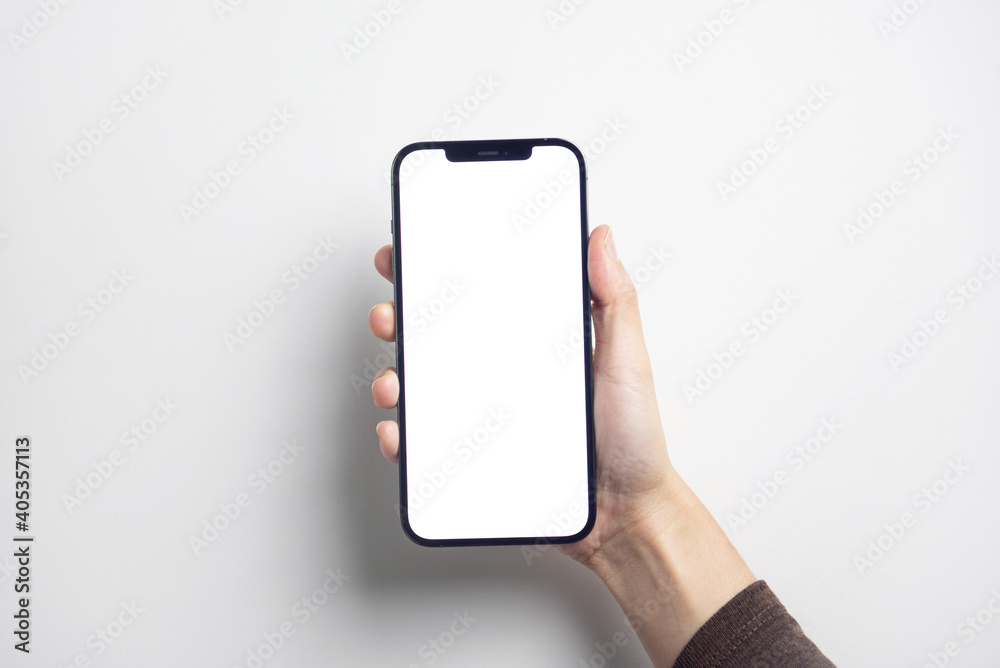 Hand holding black smartphone iPhone 12 Pro Max with white screen ...