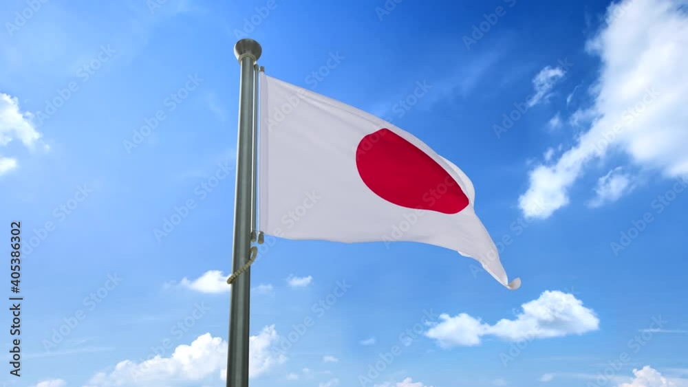 The national flag of Japan waving in the breeze, under the blue sky and ...