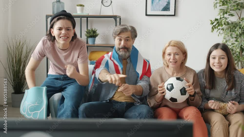 Vidéo Stock Slow motion of cheerful football fans happy family watching ...