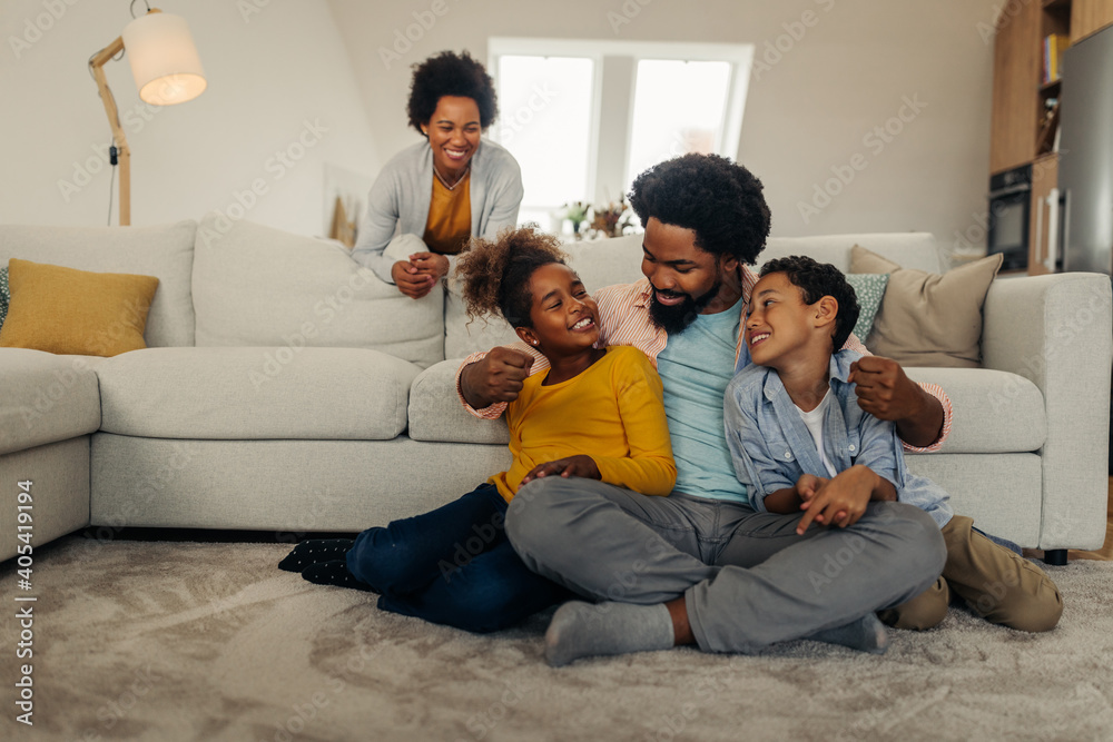 Afro parents and their children bonding at home Stock Photo | Adobe Stock