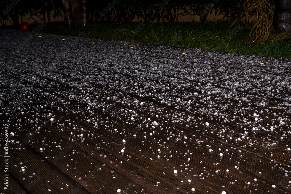 Large grains of hail on a black background. Background, texture. After ...