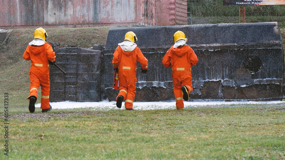 Firefighter fighting with flame using fire hose chemical water foam ...