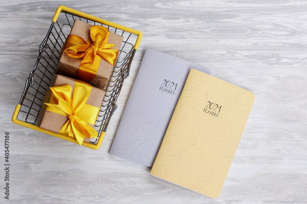 Two gift boxes wrapped by kraft brown paper with beautiful yellow satin ...