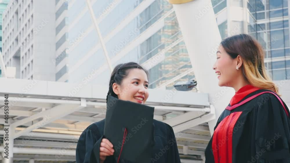 Young asian women in graduation gown outfit meeting outdoor throw hat ...