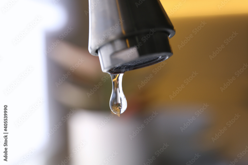 Water drop falling down from tap on blurred background, closeup Stock ...