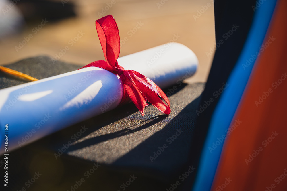 Selective and close-up focus of a university graduate holds a degree ...