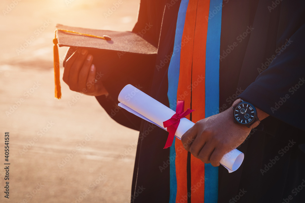 Foto de Selective and close-up focus of a university graduate holds a ...