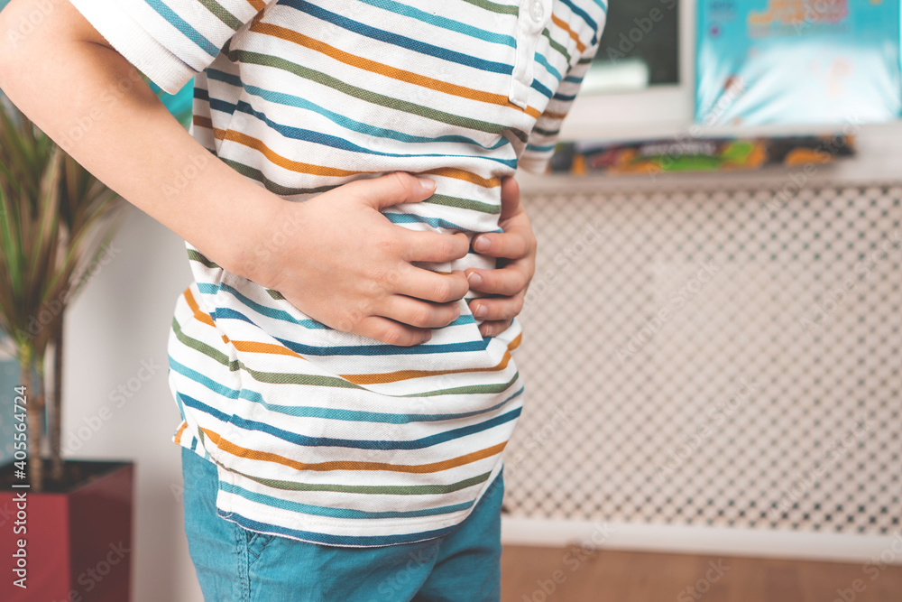 child keeps hands on belly at home. abdominal pain in a child ...