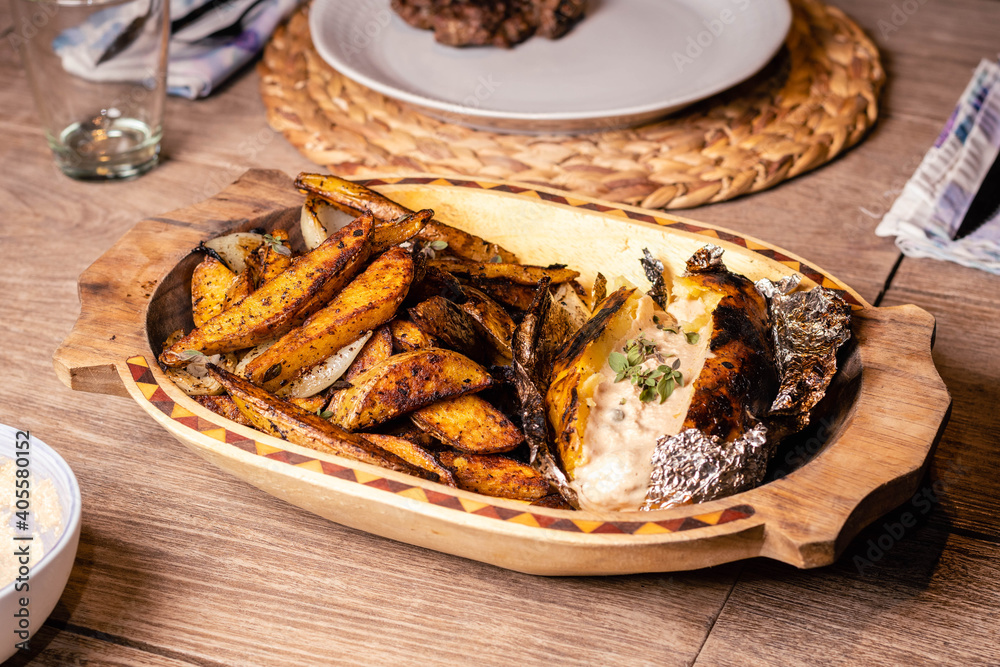 steel grilled meat burger with wood flame fries in metallic foil herbs ...