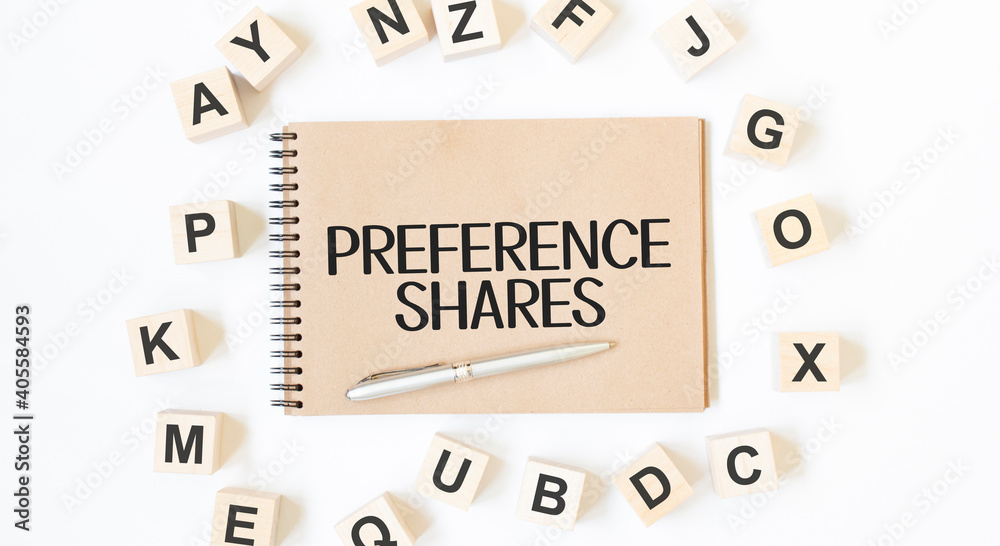 Text PREFERENCE SHARES on the craft colored notepad with block wood ...