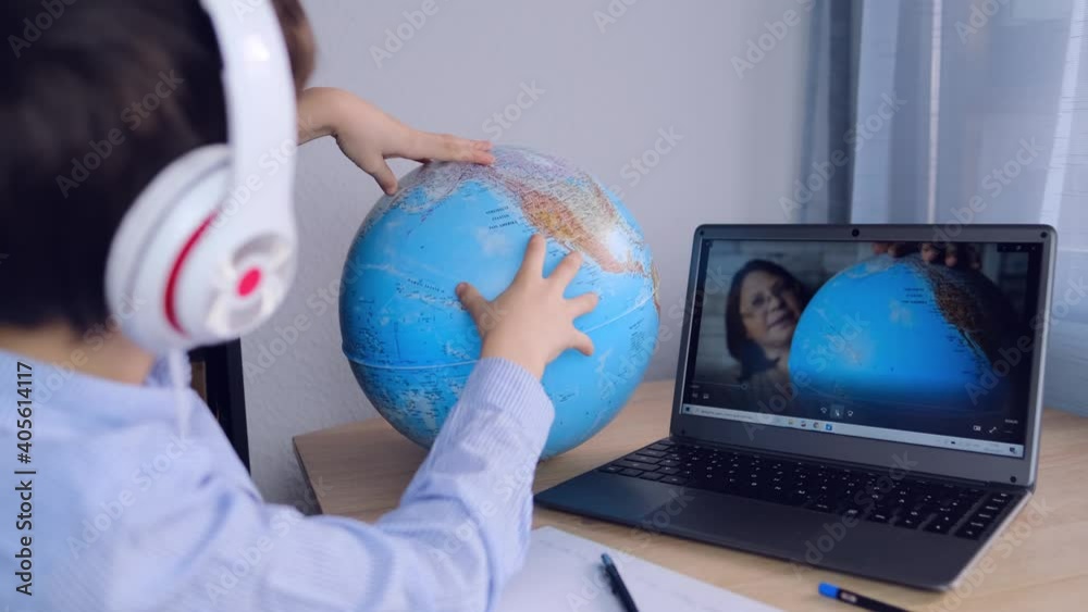 At home cute boy doing his online school classes he have a conversation ...