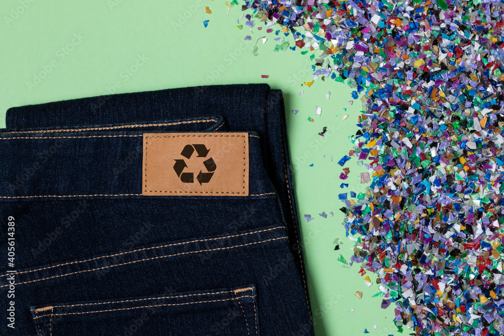 Recycled blue jeans with a clothing label. Circular economy principle ...