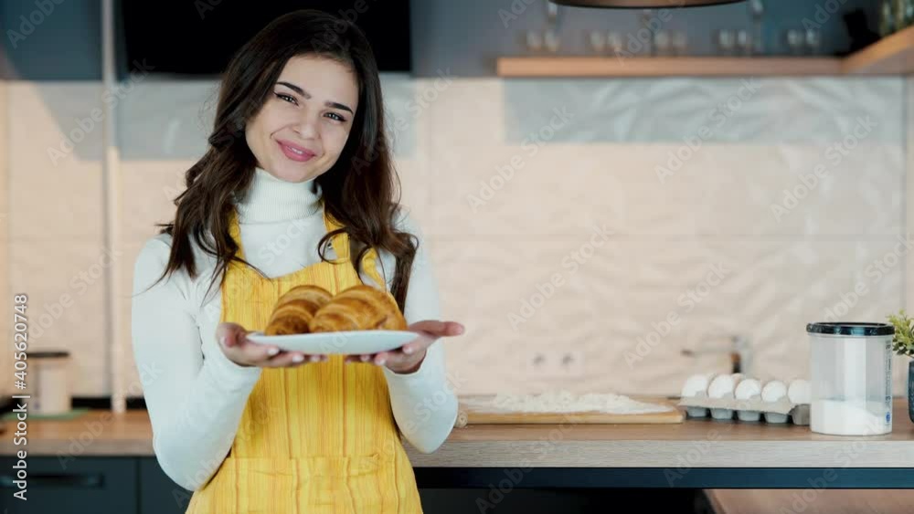 Young funny woman smeared her face with flour while cooking. She does ...