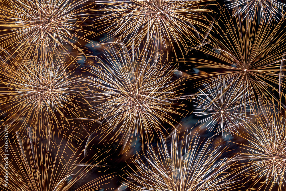 Festive colorful bright fireworks in night sky during celebration ...