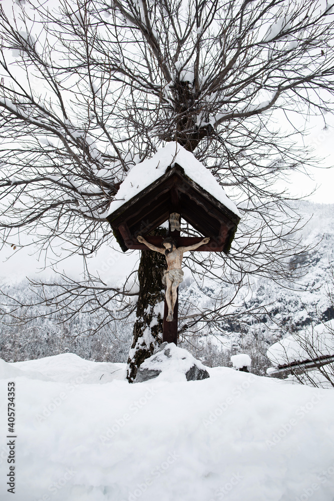 Crucified Jesus Christ covered by snow in harsh winter in East Tyrol in ...