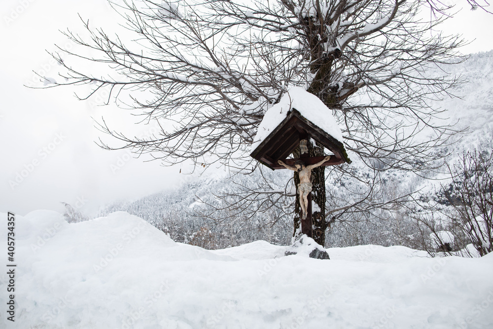 Crucified Jesus Christ covered by snow in harsh winter in East Tyrol in ...