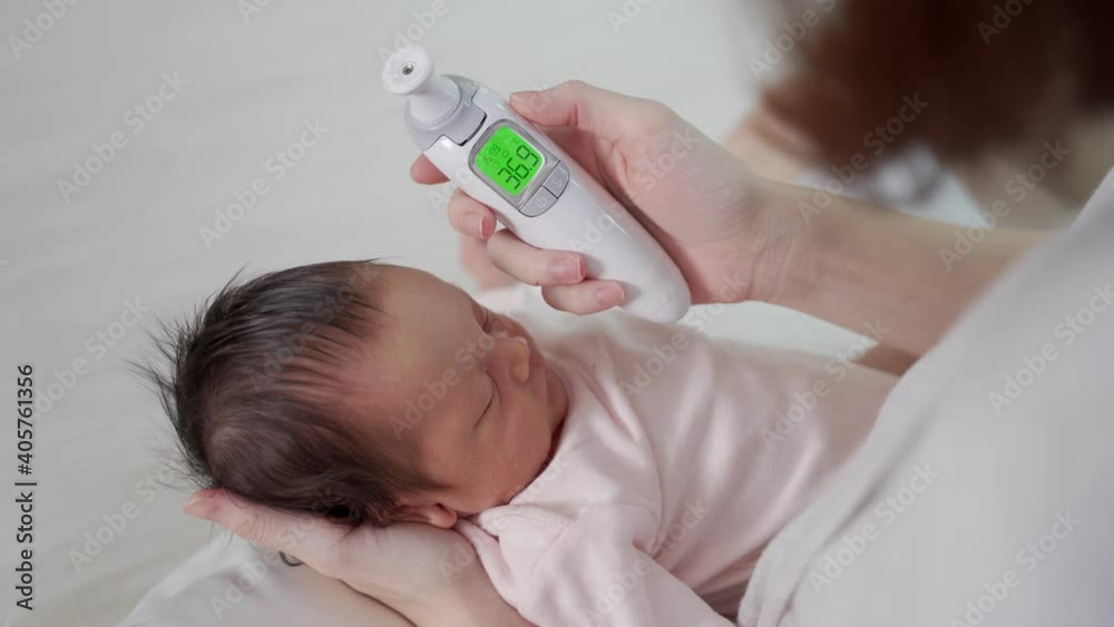 asian woman mother using digital thermometer scan baby infant ...