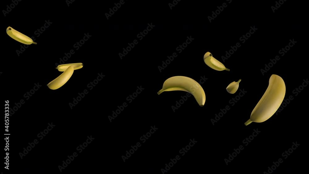 Fresh bananas flying in slow motion against a black screen background ...