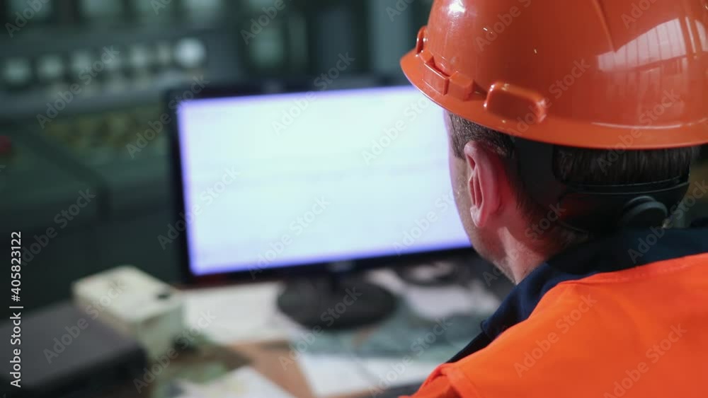 Inside heavy industry, factory male industrial engineer works on ...