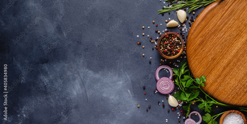 Herbs and condiments on black stone background. Stock Photo | Adobe Stock
