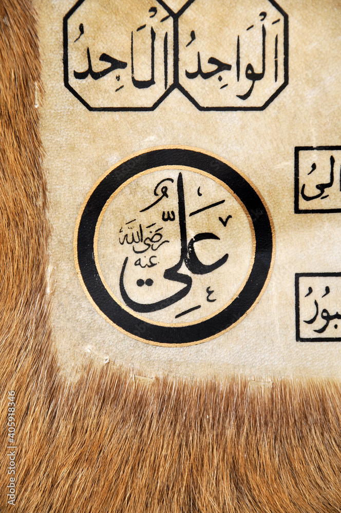 Name of Ali, islamic calligraphy characters on skin leather with a hand ...
