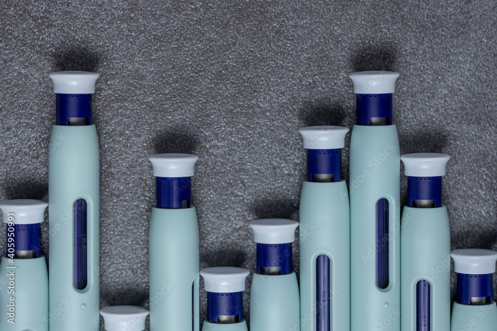 Protected top parts of syringe self application pens casting shadows on ...