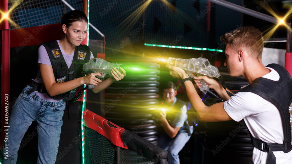 Girl with laser guns took aim and having fun with friends during laser ...