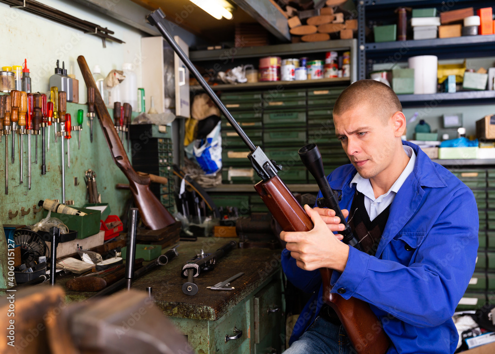 Skilled gunsmith installing optical sight on smallbore single-barreled ...