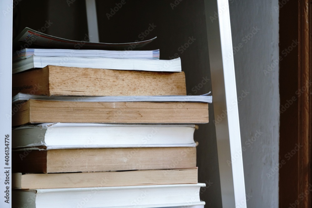Side view of many old books stacked on the bookshelf after read. Stock ...