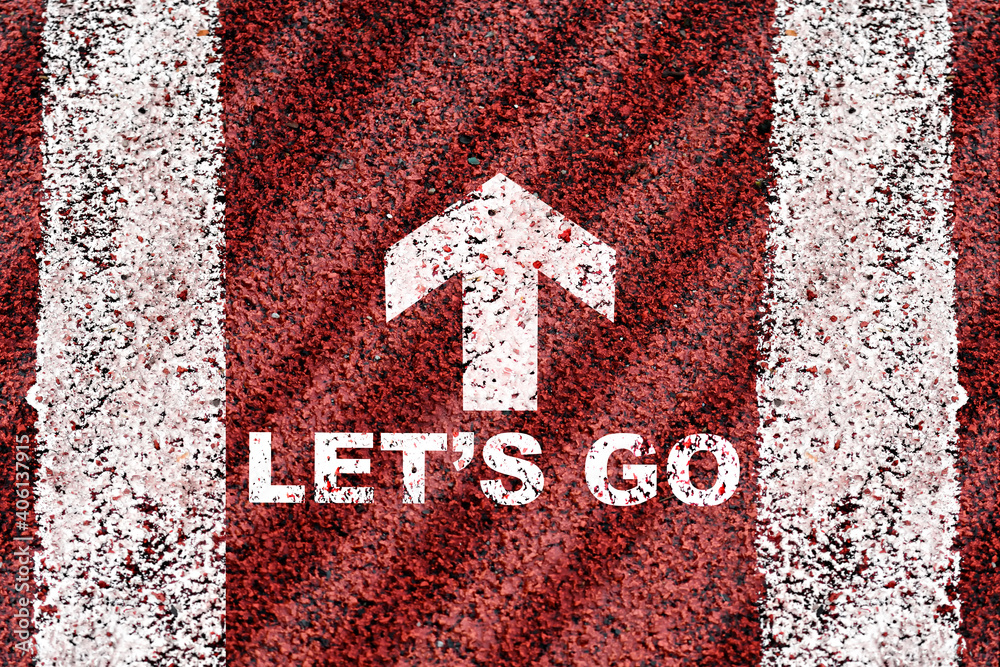 Lets go word and white arrow written on road surface with marking lines ...