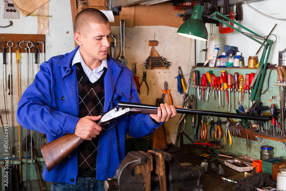 Gunsmith examines and checks appearance of the semi-automatic rifle ...