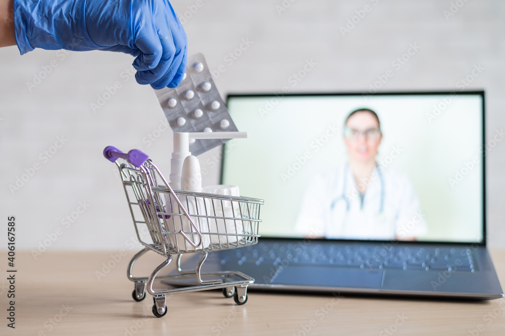 A friendly doctor conducts an online consultation on a laptop. A gloved ...