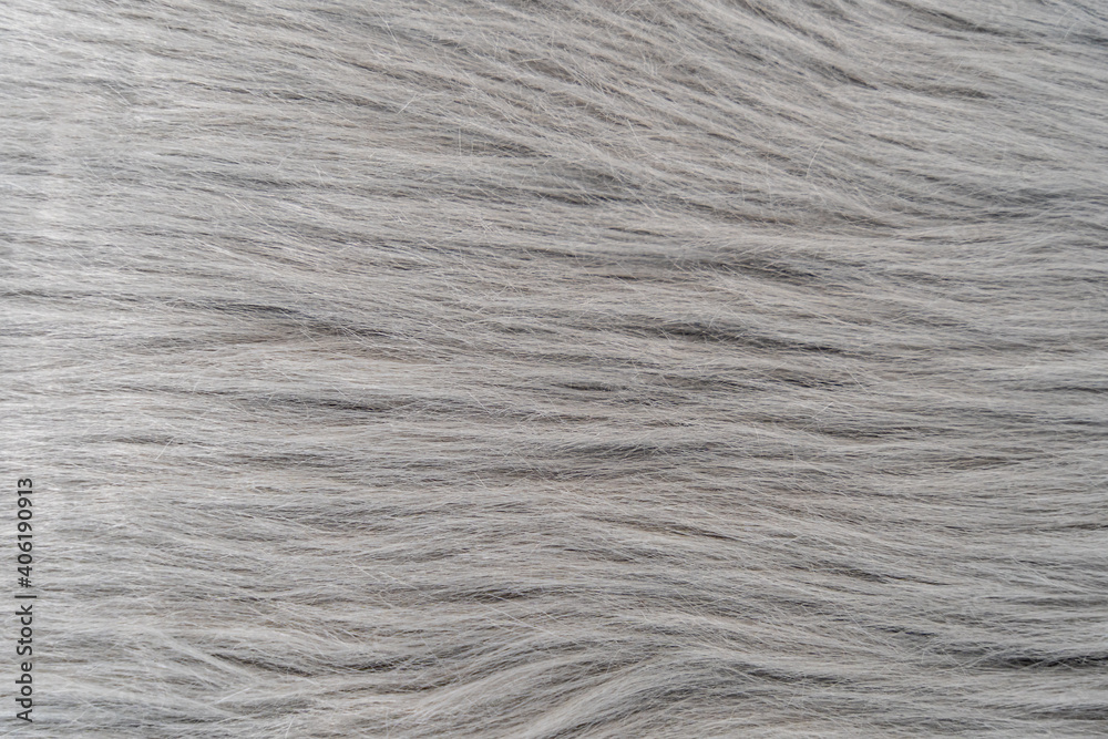 Grey fur rug texture of a textile with long fibers. Natural structure ...