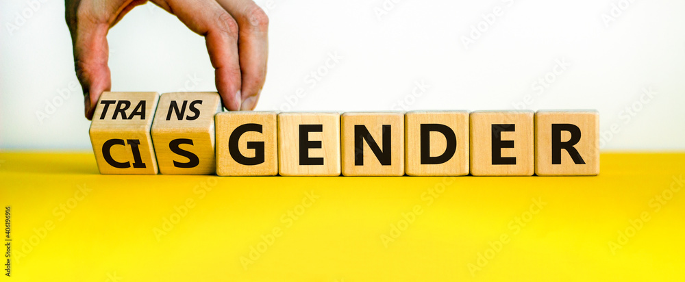 Transgender or cisgender symbol. Male hand flips wooden cubes and ...