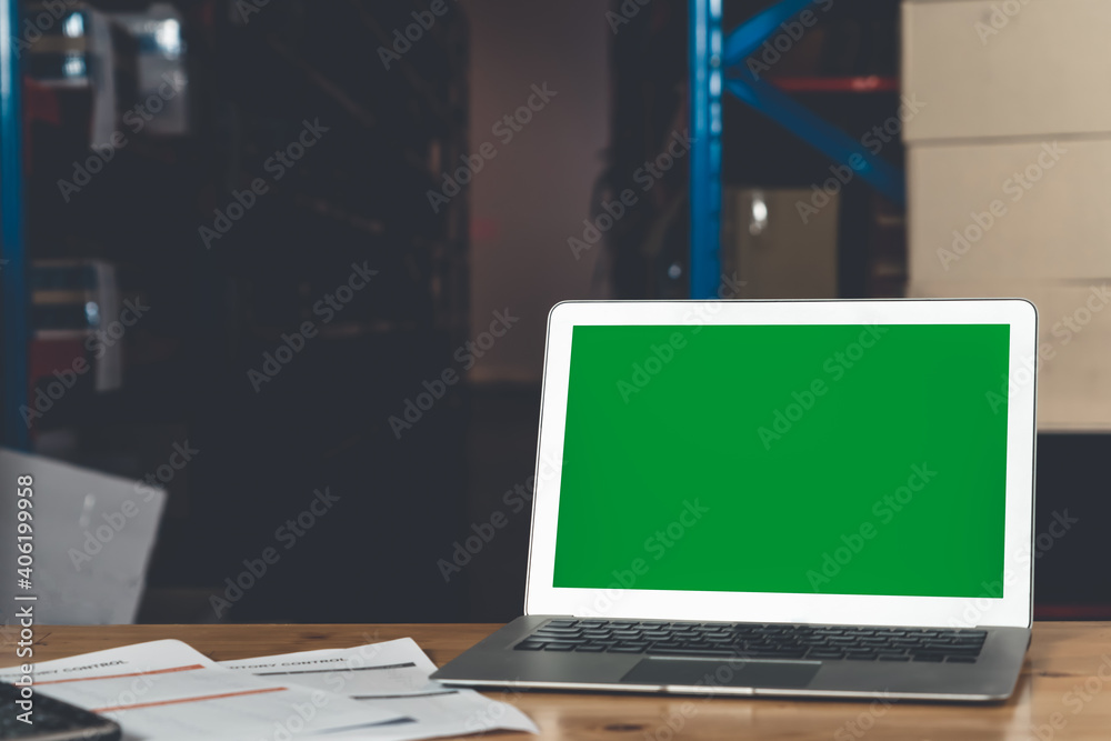 Computer with green screen display in warehouse storage room . Delivery ...