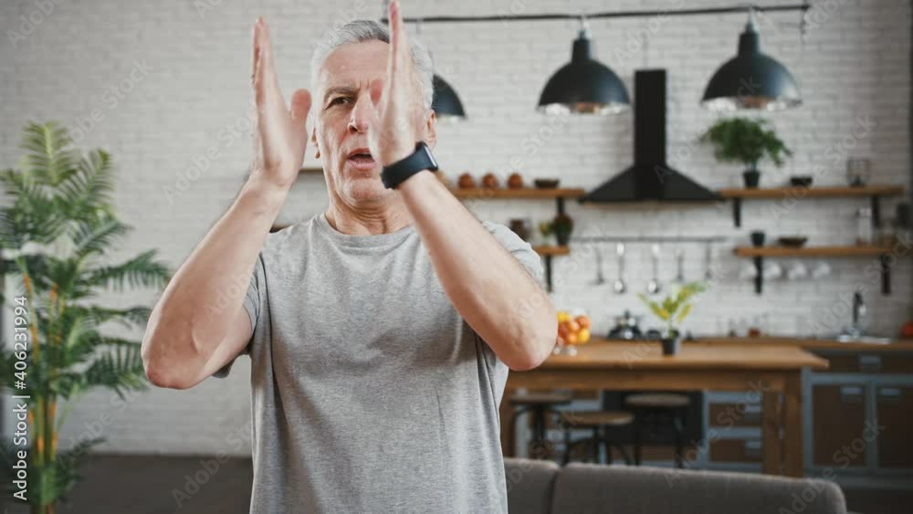 Aged athletic male is setting timer on smartwatch gadget and holding ...
